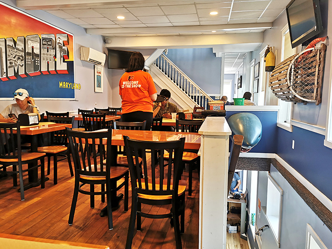 Inside, nautical blue walls and the "Greetings from Baltimore" mural create that perfect balance of local pride and maritime charm.