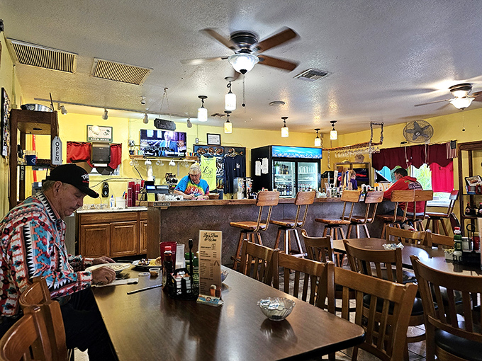 Inside Leo's, wooden tables, ceiling fans, and yellow walls create that perfect "grandma's kitchen" vibe where calories don't count and coffee cups are never empty.
