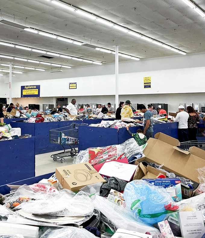 Treasure hunting in action! Shoppers dive deep into the blue bins, where yesterday's retail becomes today's discovery in this modern-day gold rush.