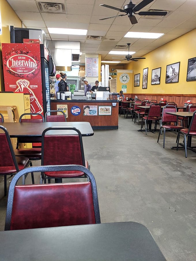 Inside, yellow walls and burgundy chairs create the perfect no-nonsense environment for serious burger business. Note the Cheerwine signage&mdash;you're definitely in North Carolina.