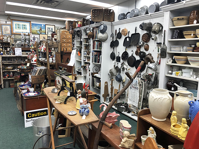 Kitchen archaeology at its finest! Cast iron collections tell culinary stories spanning generations, while ceramic figurines stand guard over forgotten recipes and timeworn tools.