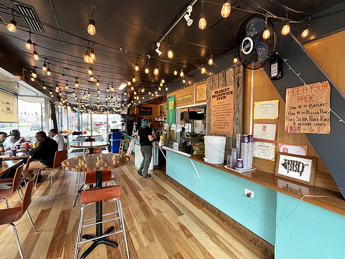 String lights dance overhead while the aroma of slow-smoked meats creates an atmosphere that's equal parts rustic charm and culinary anticipation. 