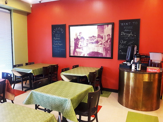 Vibrant red walls and green tablecloths create a warm embrace, while chalkboard menus promise handcrafted delights that'll make you forget your diet resolutions.