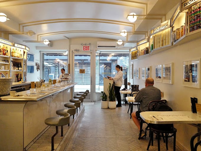 Step inside and time slows down &ndash; the gleaming white tiles and herringbone floor create an atmosphere where nostalgia meets modern Manhattan elegance.