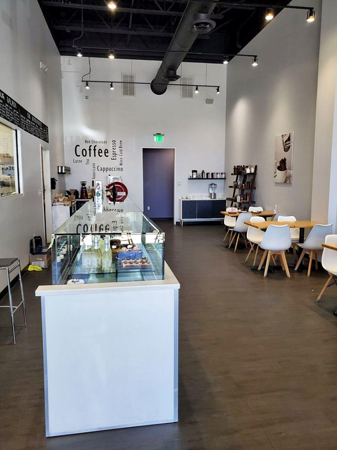 Minimalist chic meets maximum flavor in this airy interior. The coffee wall art isn't just decoration—it's a mission statement.