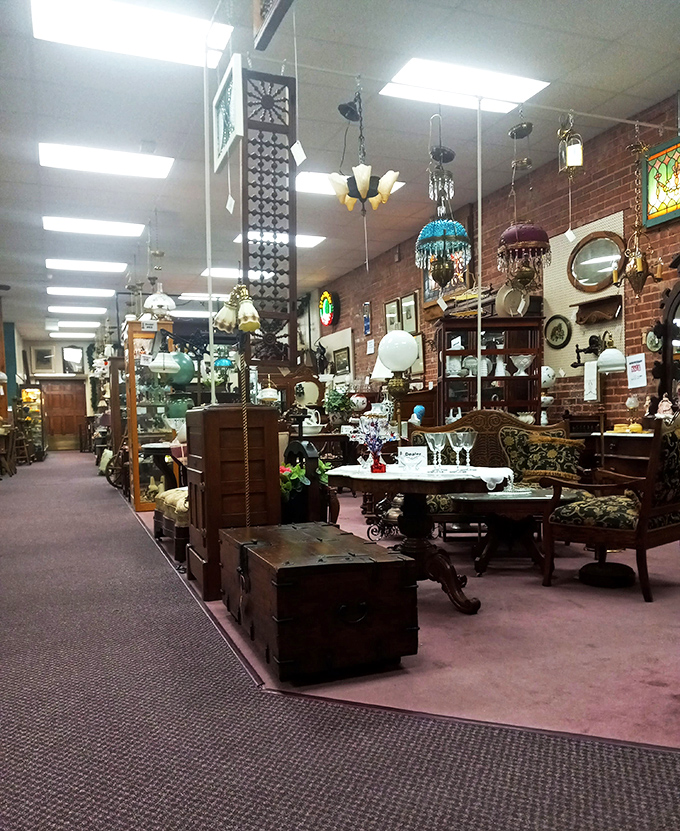 Chandeliers hang like crystallized memories above antique furniture, creating pathways through history where every turn reveals another vendor's carefully curated collection.