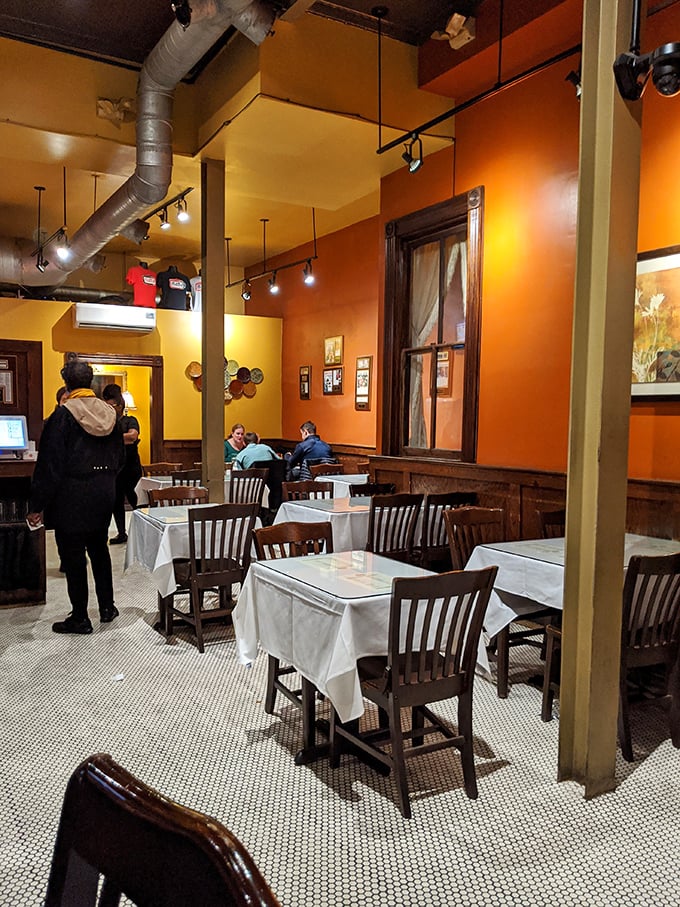 Warm orange walls and white tablecloths create that perfect sweet spot between "special occasion" and "come as you are" comfort.