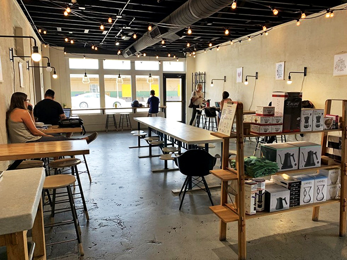 Minimalist design meets maximum comfort in City & State's airy interior, where string lights and communal tables create Memphis's most inviting coffee sanctuary.