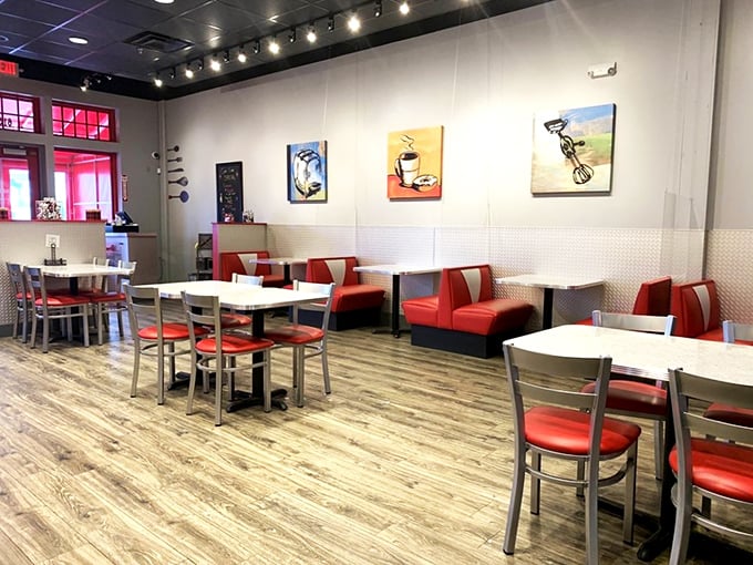 Clean lines, red booths, and food-themed art create a space that's both modern and cozy. A dining room that says "stay awhile."