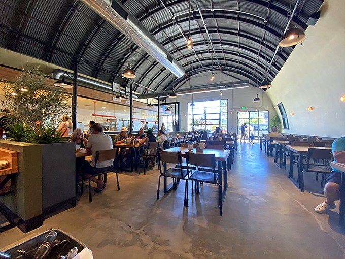 High ceilings and industrial chic meet comfort in this airy dining room, where BBQ pilgrims gather for their smoky salvation.