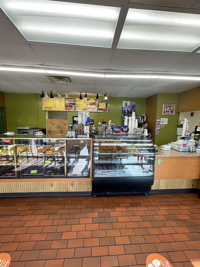 Donut paradise awaits behind glass barriers. The display cases at Yummy's are like museum exhibits, except you're encouraged to eat the masterpieces.