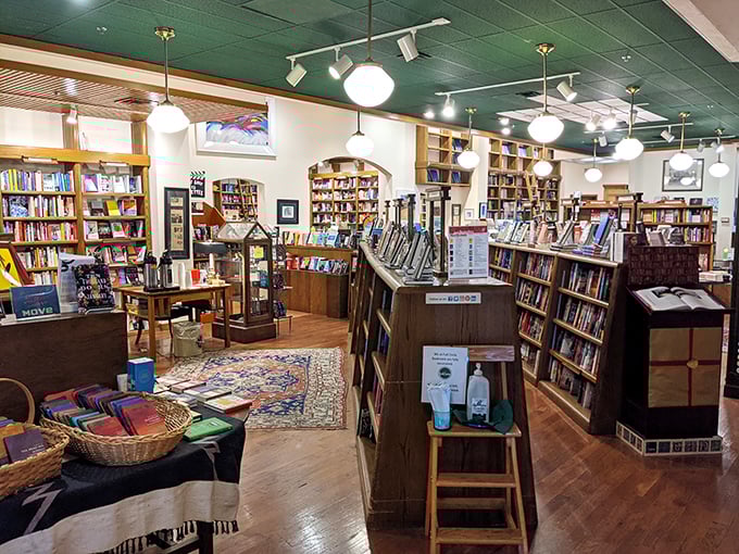 Wooden shelves stretch toward the green ceiling, creating a labyrinth of literary possibilities where time seems to stand wonderfully still.