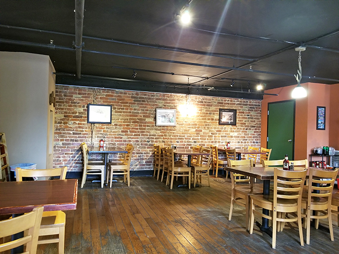 Inside, exposed brick walls and warm wooden floors create the kind of cozy atmosphere that makes you want to loosen your belt before you've even ordered.