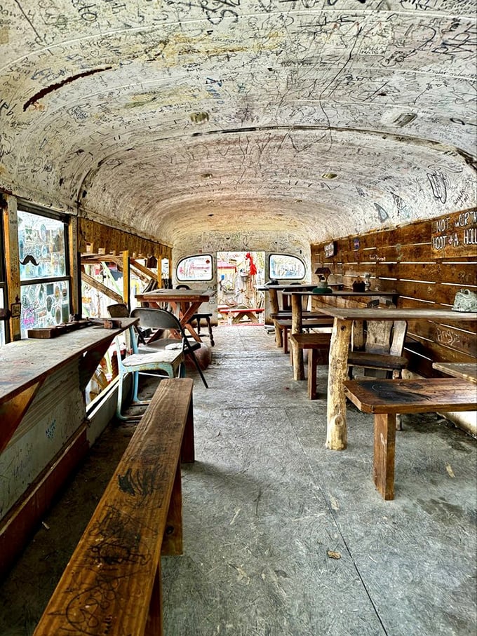 The famous school bus dining room, where thousands of visitors have left their mark. It's like eating inside a yearbook that serves incredible hot dogs.