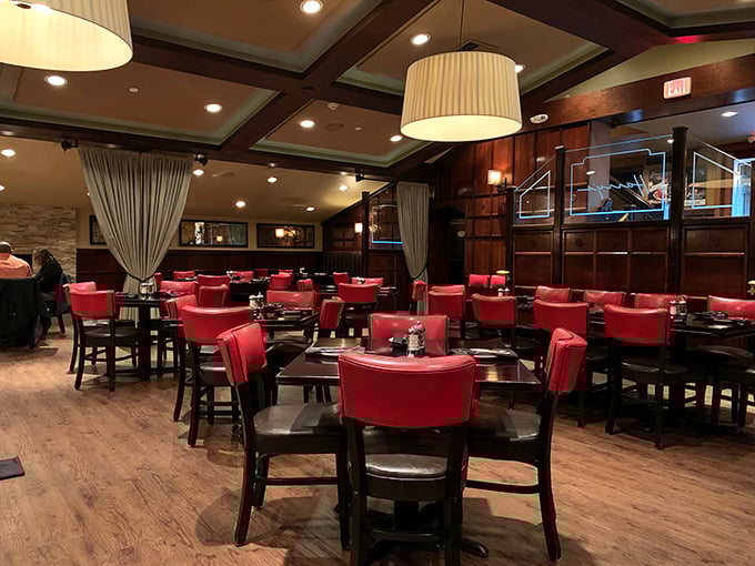 Red chairs await like loyal butlers in Harry's dining room, where the wood-paneled ambiance whispers "special occasion" even on a Tuesday.