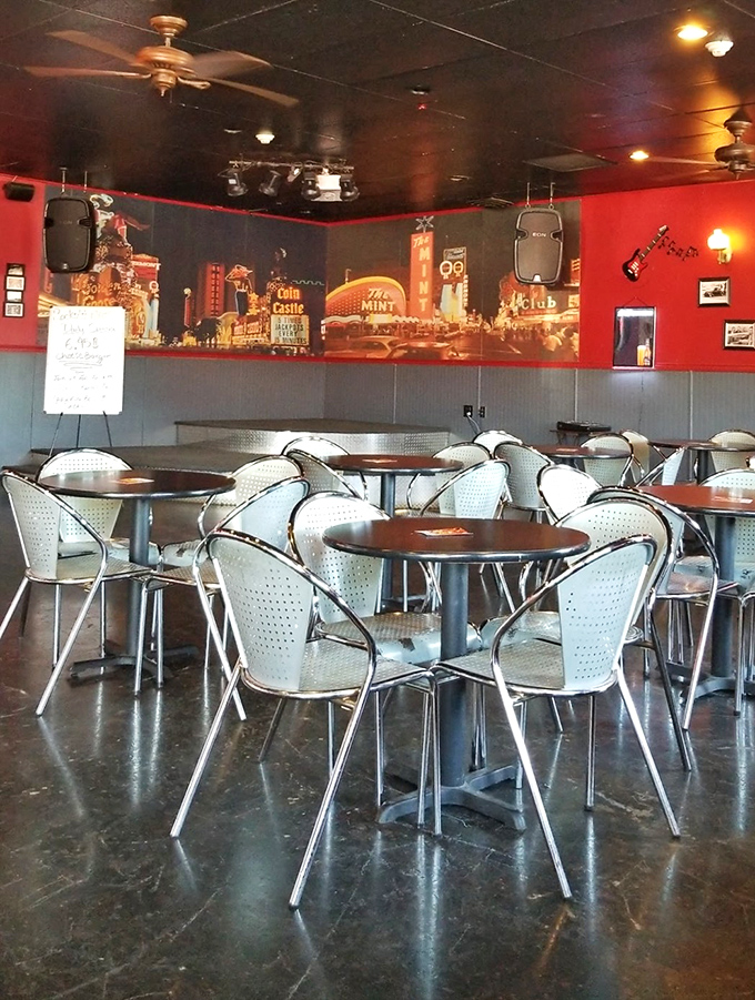 Step inside and you're transported to a bygone era—chrome chairs, red walls, and a Vegas skyline mural that practically croons Sinatra tunes at you.