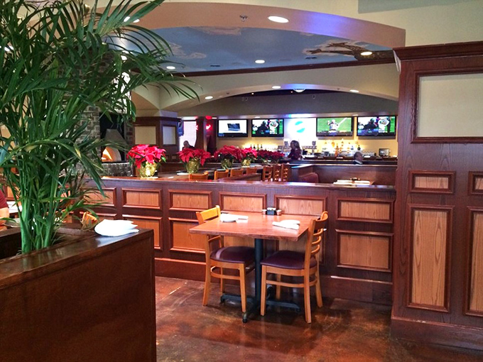 Warm wood paneling and lush greenery create that perfect "fancy but not too fancy" vibe. The kind of place where you can wear your good jeans.