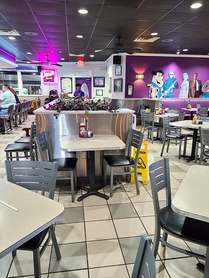 Step inside and the retro charm explodes with chrome fixtures, purple accents, and cartoon murals that make adults feel like kids again.