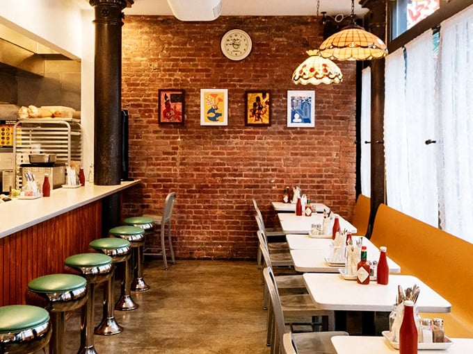 Mint green counter stools, exposed brick, and vintage pendant lights&mdash;this isn't your grandfather's diner, but he'd still feel right at home.
