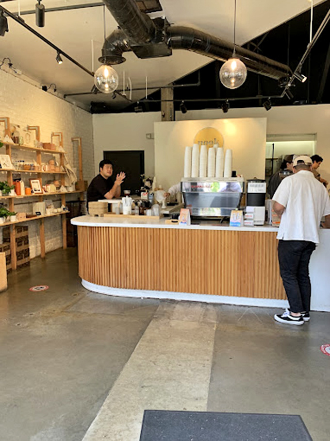 Inside, industrial chic meets genuine warmth. The curved wooden counter serves as mission control for caffeine adventures that transcend ordinary coffee breaks.