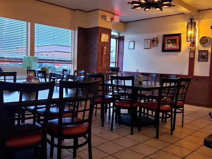The dining room's simple elegance says, "We're focusing on the food, not fancy chandeliers." Those wooden chairs have supported thousands of satisfied diners.