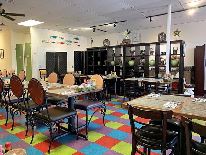 The colorful checkerboard floor and eclectic decor create a playful vibe that says "serious about food, not so serious about matching furniture."