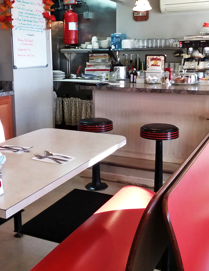 Classic counter seating where culinary magic happens just feet away. Those red-trimmed stools have witnessed countless coffee refills and life stories.