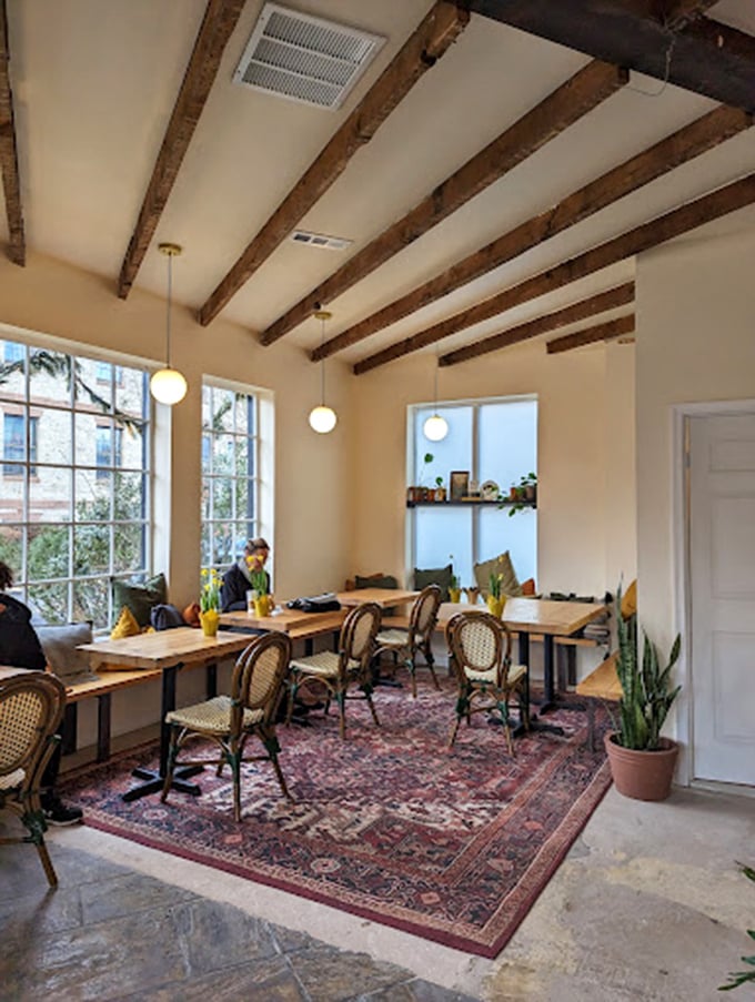 Exposed wooden beams, natural light, and that magnificent Persian rug create a space that feels like your most stylish friend's living room&mdash;if that friend made exceptional coffee.