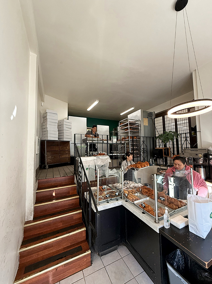 Behind the scenes magic where flour and butter transform into edible art. The wooden steps lead to what can only be described as a croissant laboratory.