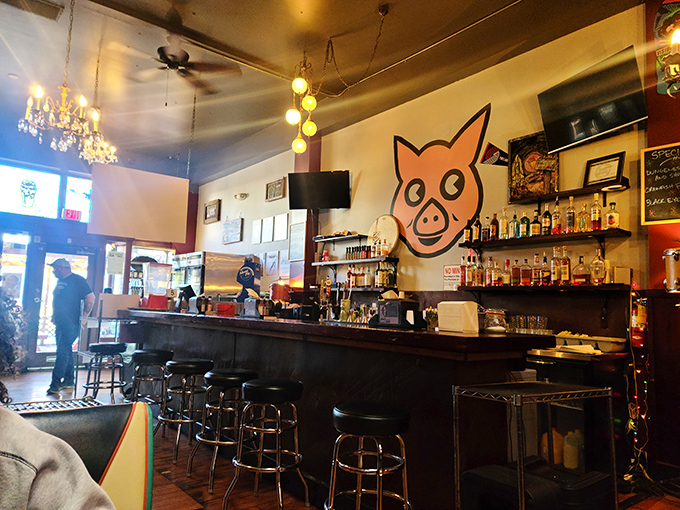 Inside, the whimsical pig mural watches over a bar stocked with Southern spirits, while chandeliers cast a warm glow that says "stay awhile, y'all."