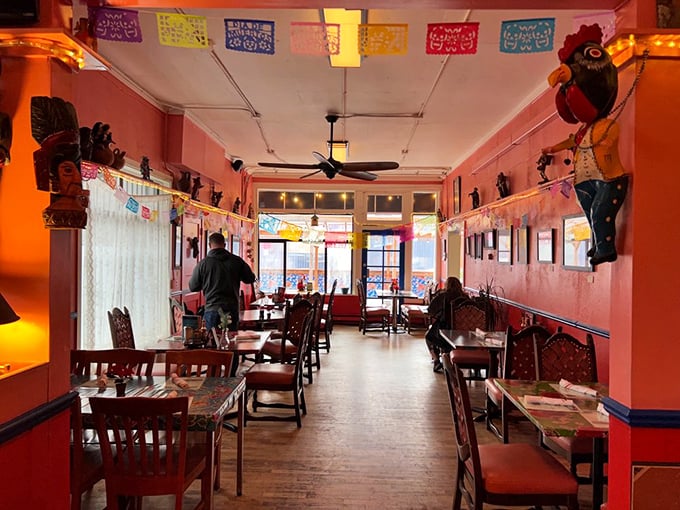 Step inside and the salmon-colored walls embrace you like a warm Mexican hug. The papel picado banners overhead are practically whispering, "Stay awhile, amigo."