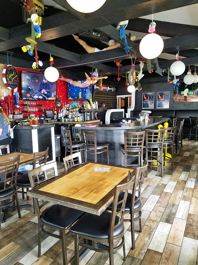 Dive into nautical whimsy with colorful fishing lures dangling from ceiling beams – like a fisherman's tackle box and tiki bar had a decorating party.