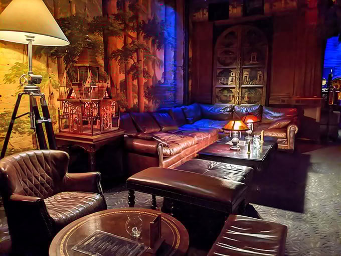 Leather couches bathed in moody lighting create the perfect nook for sipping cocktails while surrounded by woodland-inspired murals and vintage curios.