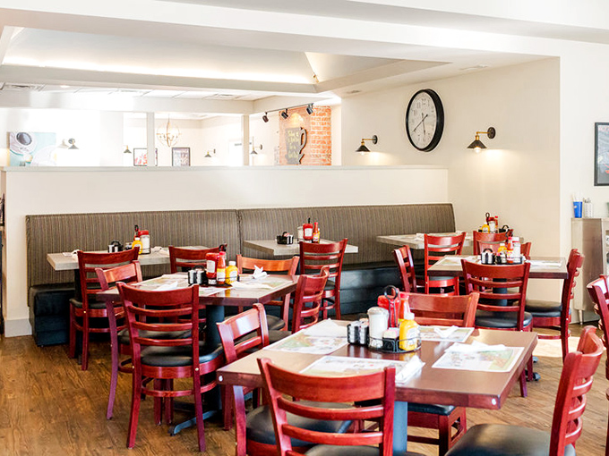 Red chairs, wooden tables, and cozy booths create that perfect diner atmosphere where conversations flow as freely as the coffee refills.
