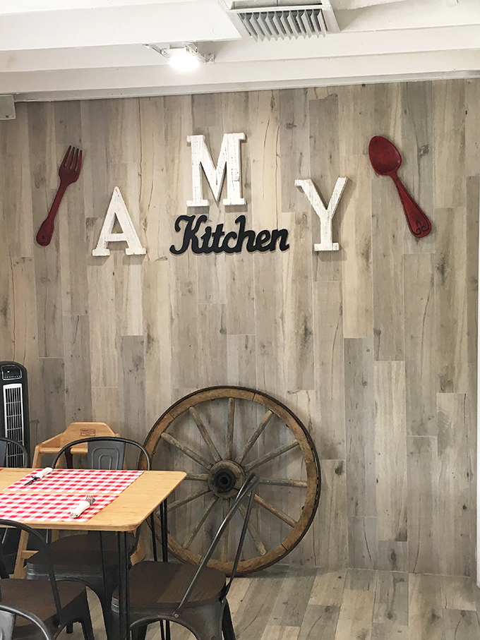 The "AMY Kitchen" wall d&eacute;cor perfectly captures the bistro's homespun charm. That wagon wheel isn't just for show&mdash;it's wheely important to the rustic ambiance.