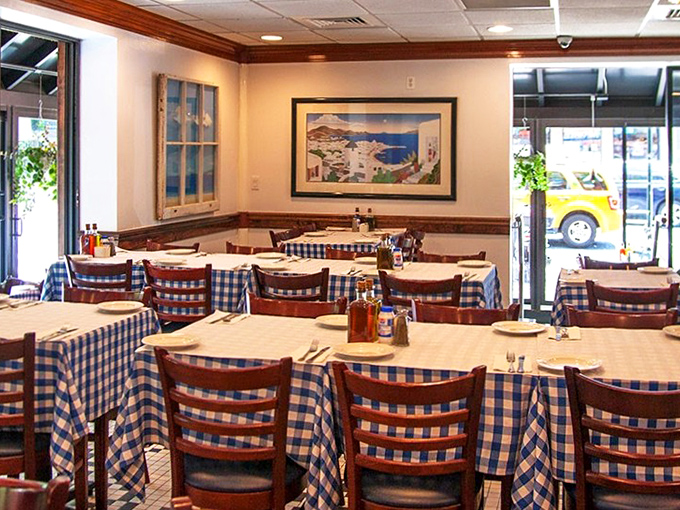 Classic blue-checkered tablecloths and warm wooden chairs create that "Yia-yia's dining room" feeling. Santorini views included, no passport required.