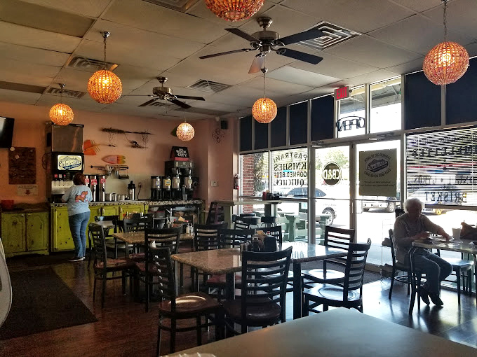 Amber globe lights cast a warm glow over conversations and coffee cups. This isn't just a meal; it's a neighborhood living room with better food.