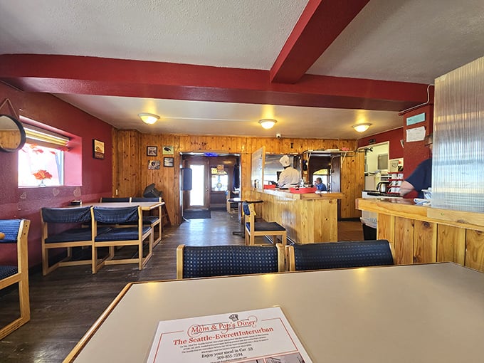 Wooden booths worn smooth by decades of elbows and conversations. The red beams overhead aren't just structural&mdash;they're framing memories being made with every meal.