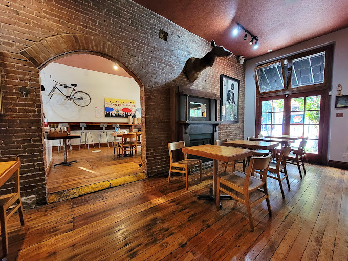 Step through the archway and time slows down – exposed brick, wooden floors, and that bicycle on the wall all conspire to make you linger longer.