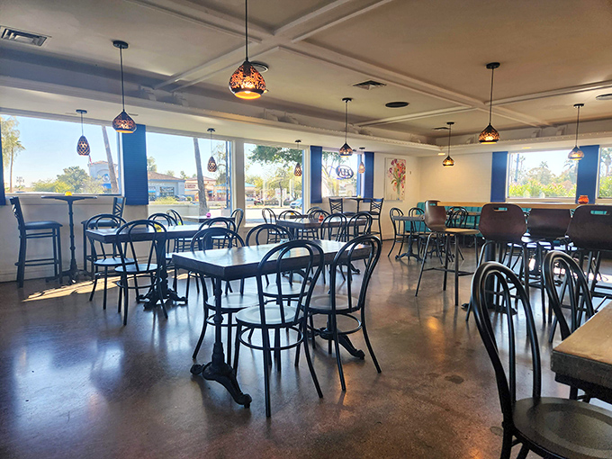 Step inside to find a bright, airy dining space where colorful pendant lights cast a warm glow over simple tables ready for serious gyro business.
