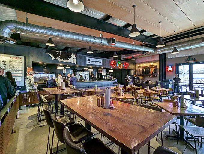 Industrial chic meets barbecue warmth inside ZZQ. Those communal tables aren't just furniture&mdash;they're where strangers become friends over brisket.