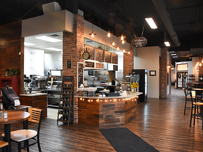 Where rustic meets refined: exposed brick walls, warm wooden accents, and pendant lighting create the kind of atmosphere that makes you want to linger over coffee.