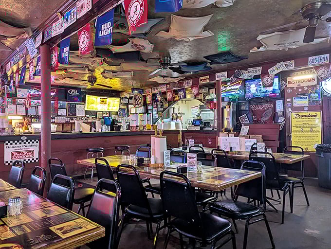 Inside Dreamland, decades of memories hang from every surface. The ceiling's dollar-bill collection might be Alabama's most delicious investment portfolio.