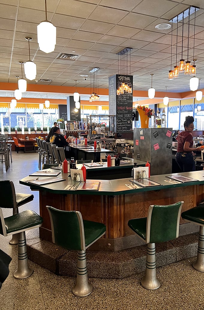 Counter seating with vintage green chairs offers front-row tickets to the breakfast theater. It's like the Breakfast Olympics, and everyone gets a medal.