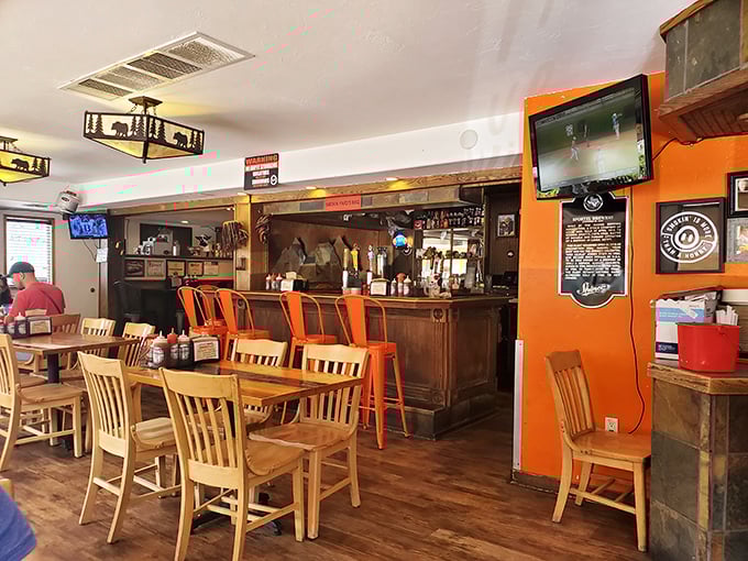 Where barbecue dreams come true. The warm orange walls and wooden tables create the perfect backdrop for the meat symphony about to unfold.