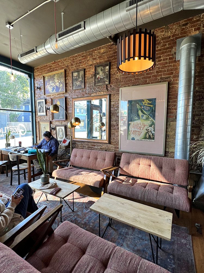 Mid-century modern meets exposed brick in this living room away from home. Those pink couches have probably heard more life-changing conversations than most therapists.