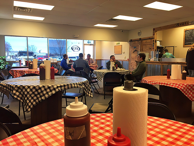Red and black checkered tablecloths set the stage for barbecue theater. No fancy linens needed when the main attraction is what's on your plate.