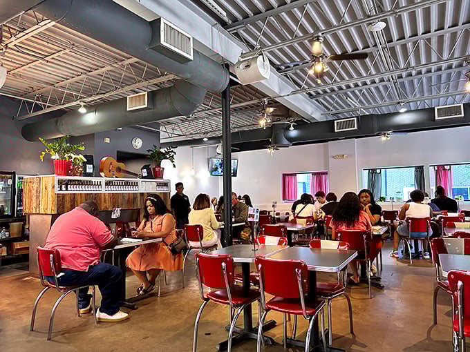 Red retro chairs invite you to settle in under industrial-chic ceilings. This isn't just a meal&mdash;it's Atlanta's morning social club in session.