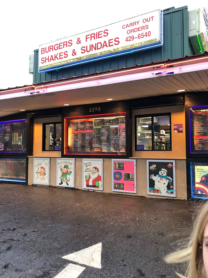 "BURGERS & FRIES, SHAKES & SUNDAES" isn't just signage&mdash;it's a declaration of purpose, complete with seasonally rotating window art that screams small-town charm.