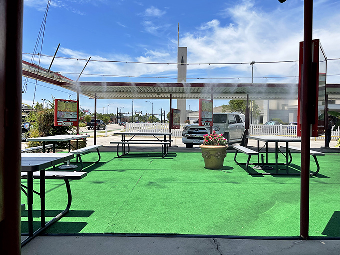 The green turf and picnic tables create an oasis of simplicity where conversations flow as easily as the milkshakes.